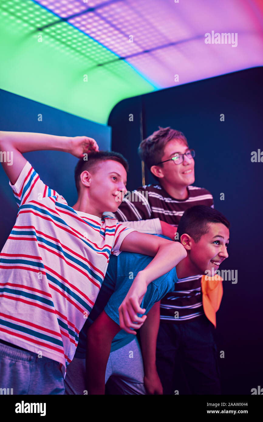 Happy teenage friends in a photo booth Stock Photo - Alamy