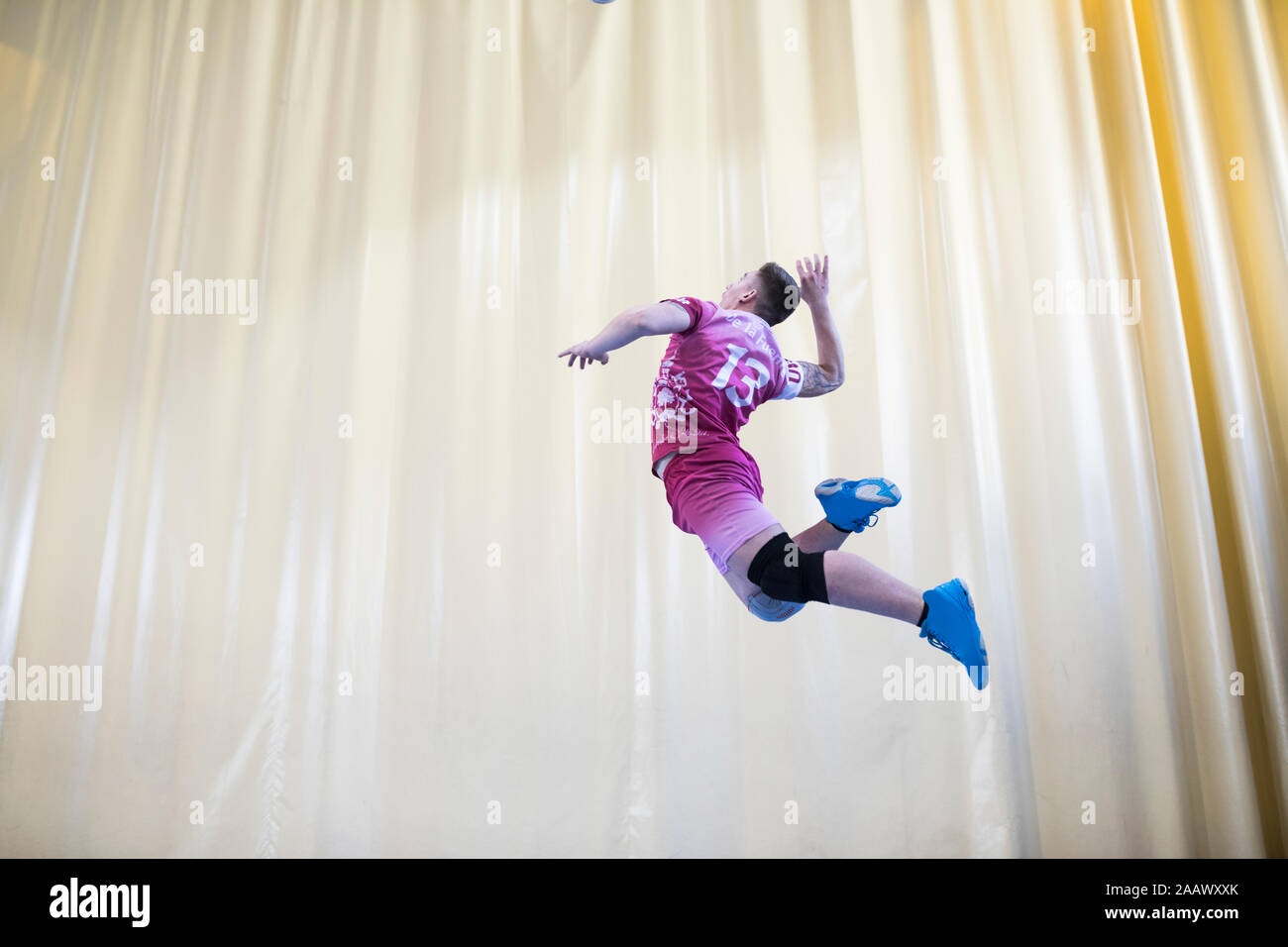 Man jumping during a volleyball match to start a game Stock Photo - Alamy