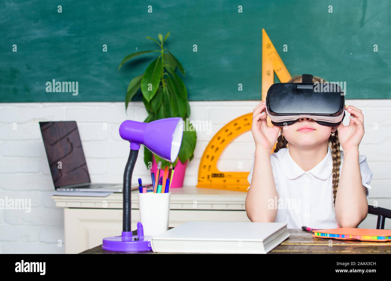 Virtual education. Child cute pupil wear hmd vr glasses. Studying in ...