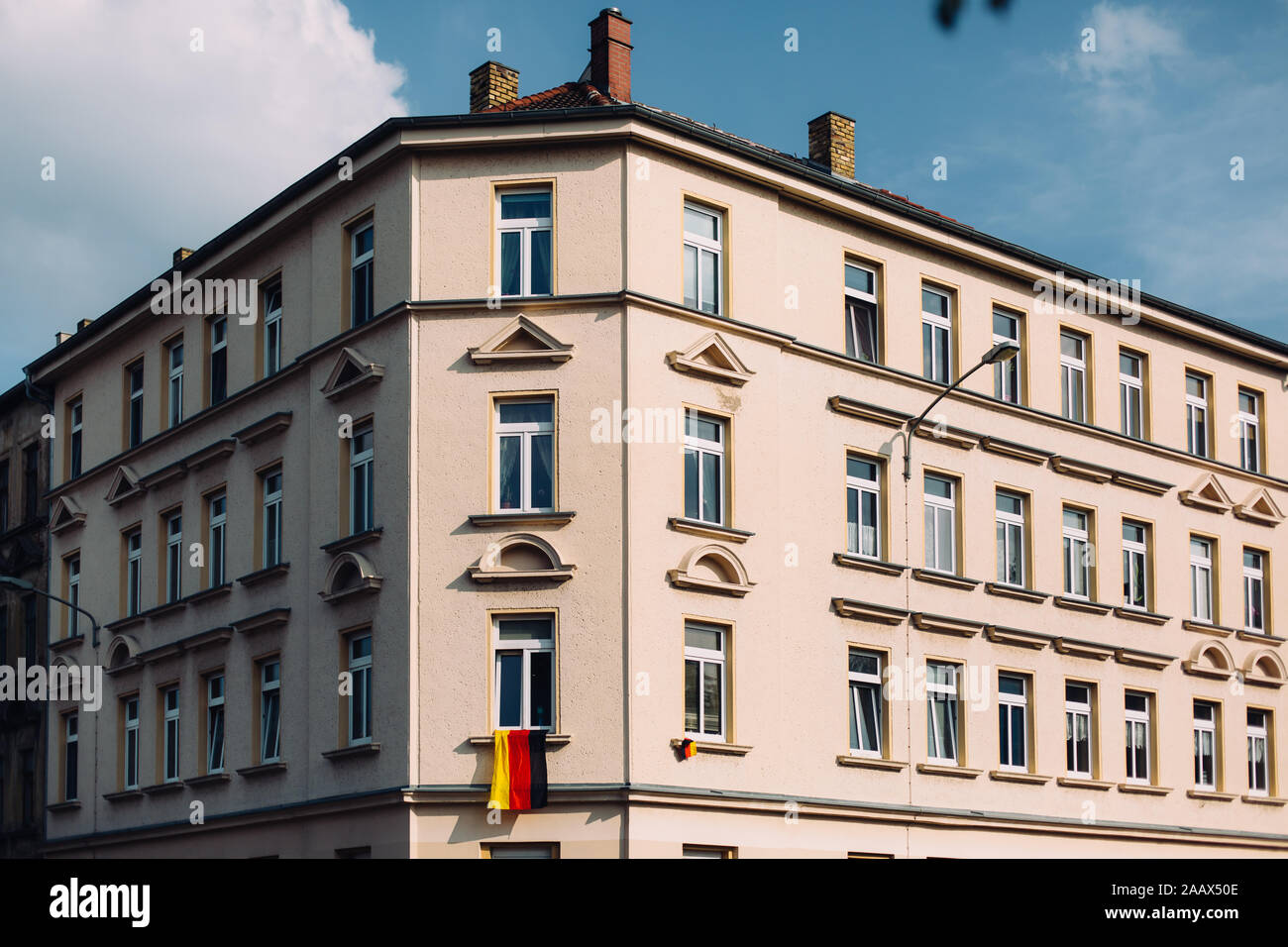 german national flag hanging outside window of an apartment building in ...