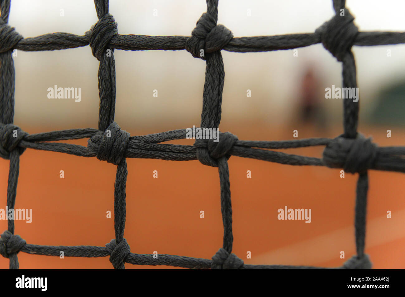 Tennis red court with gray net Stock Photo - Alamy