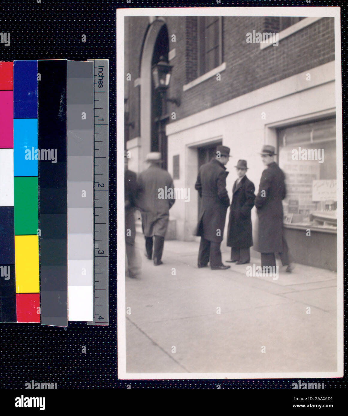 Exterior, men looking in at window display Exterior, men looking in at ...