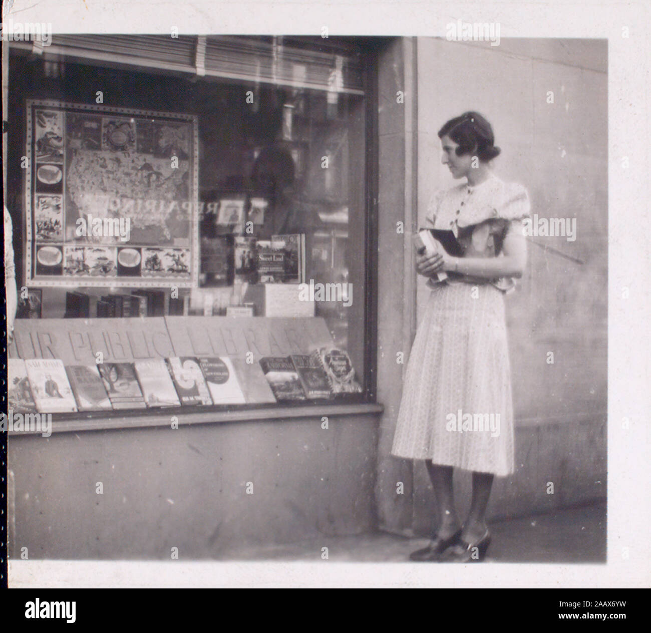 Exterior, woman looking in at window display Exterior, woman looking in ...