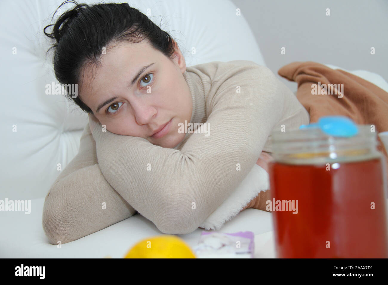 Young sick woman laying in bed Stock Photo - Alamy
