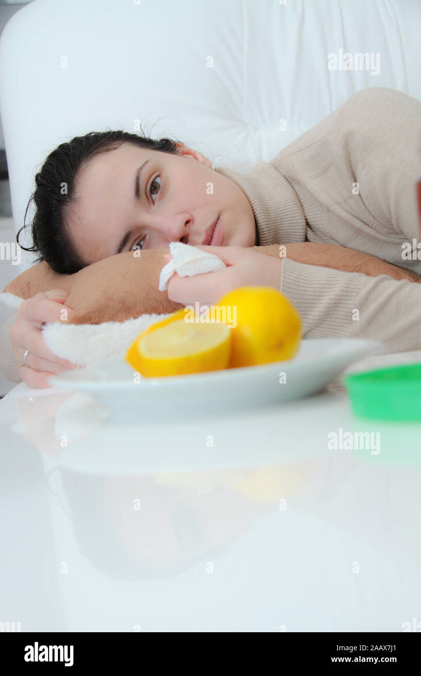 Young sick woman laying in bed Stock Photo - Alamy