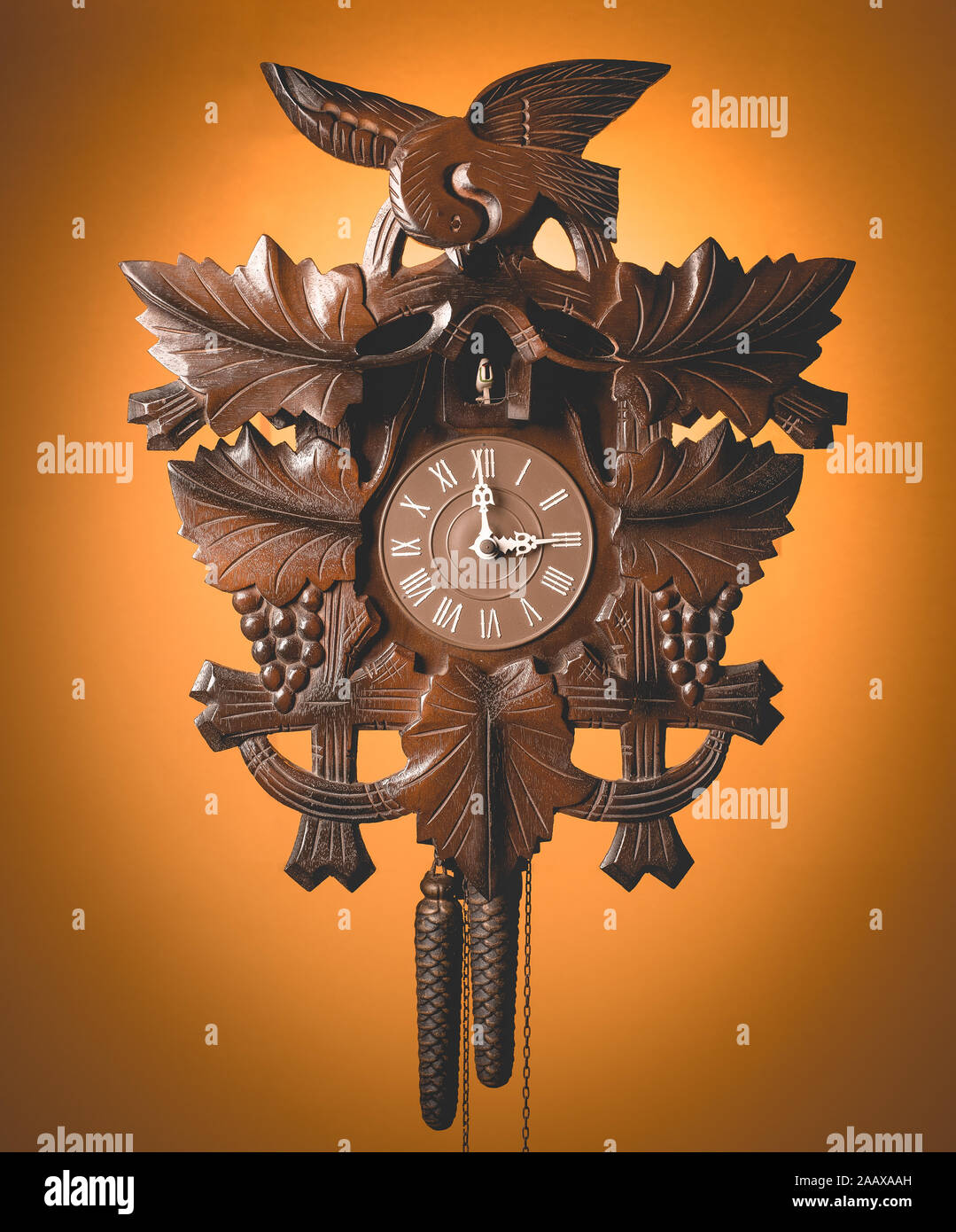 Cuckoo clock with orange background Stock Photo - Alamy