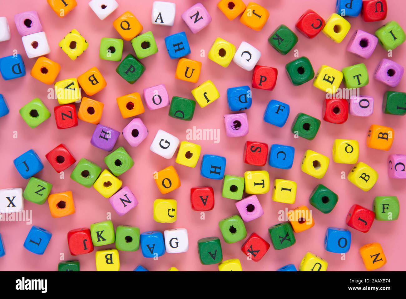 Education concept. Colorful blocks with letters on pink background ...