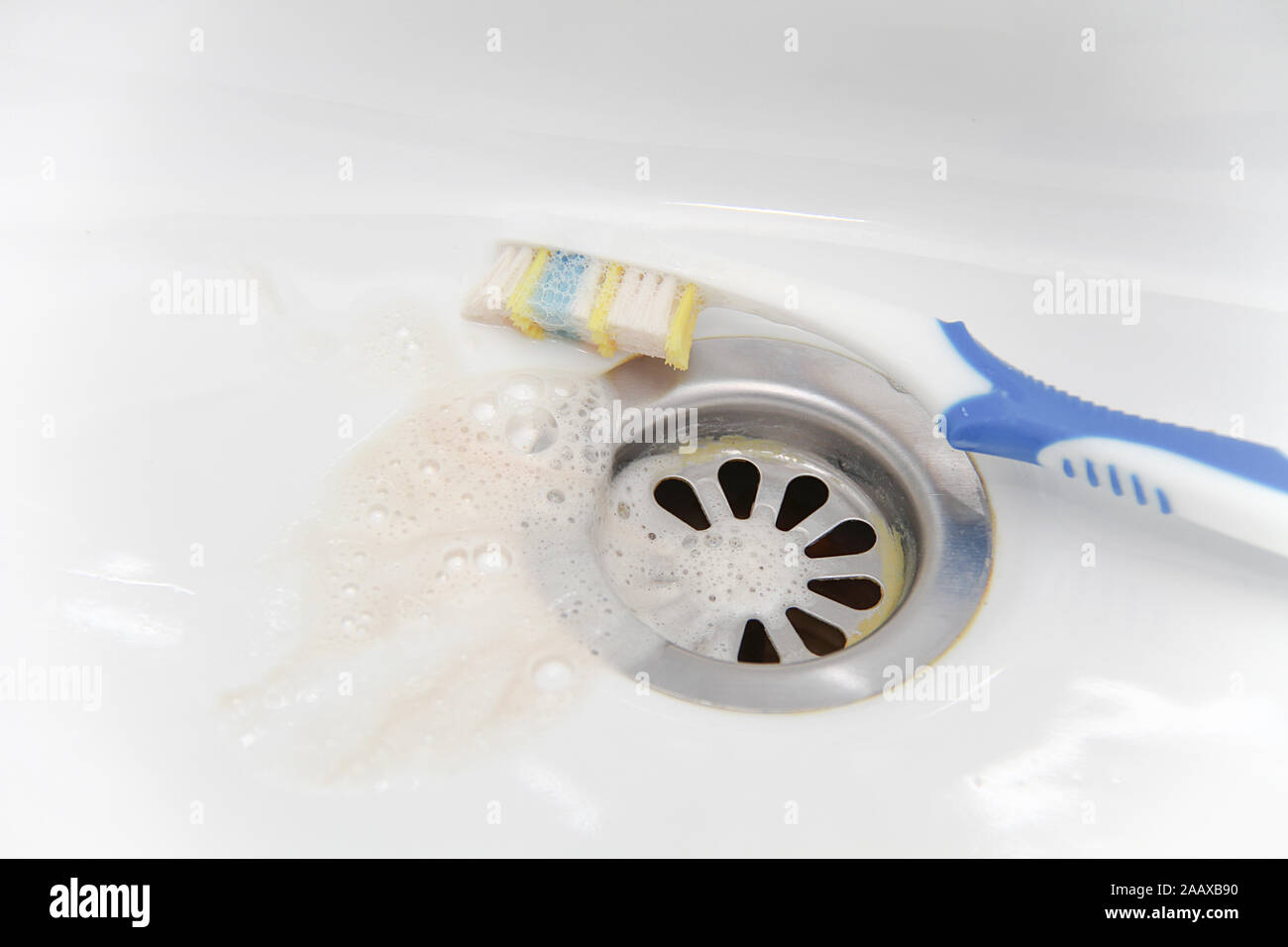 Blood and toothpaste on the toothbrush after cleaning and washing teath ...