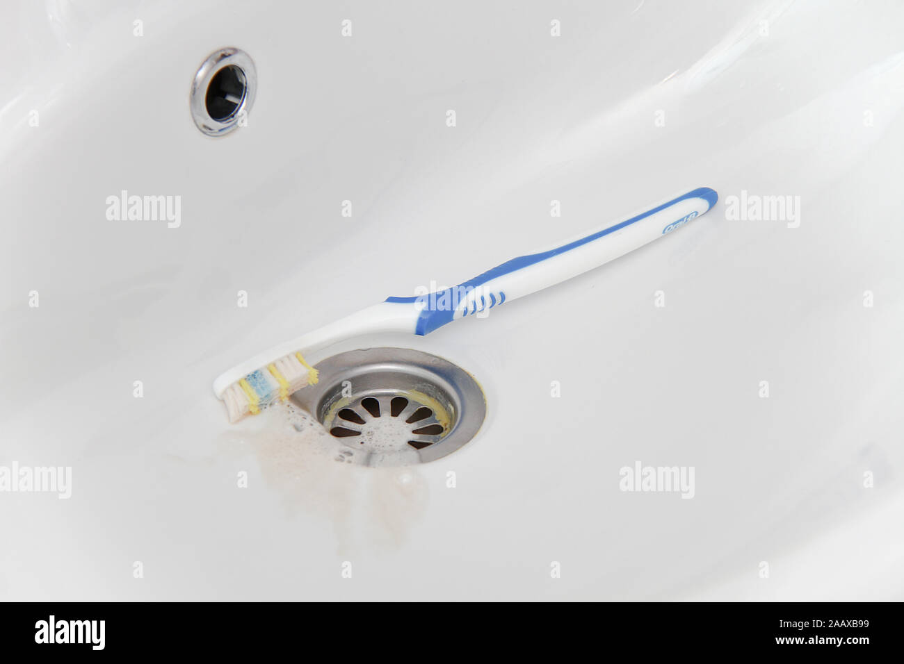 Blood and toothpaste on the toothbrush after cleaning and washing teath ...