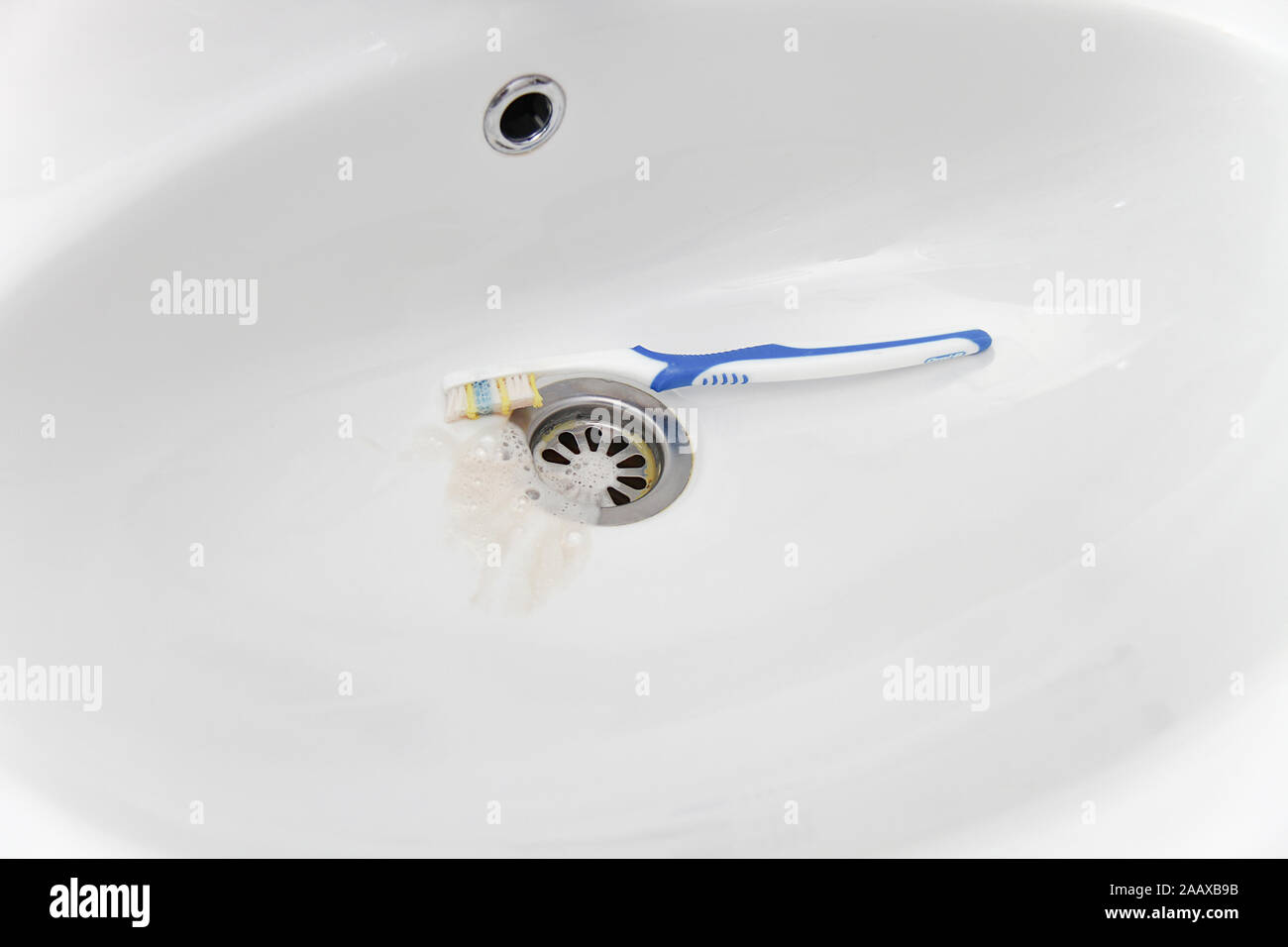 Blood and toothpaste on the toothbrush after cleaning and washing teath ...