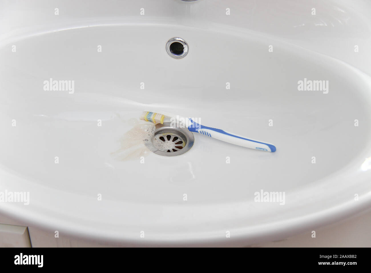 Blood and toothpaste on the toothbrush after cleaning and washing teath ...