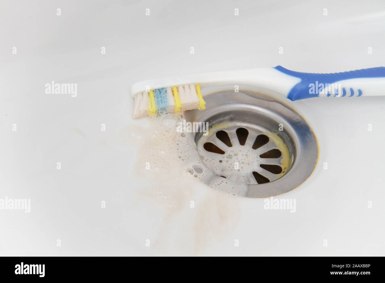 Blood and toothpaste on the toothbrush after cleaning and washing teath ...