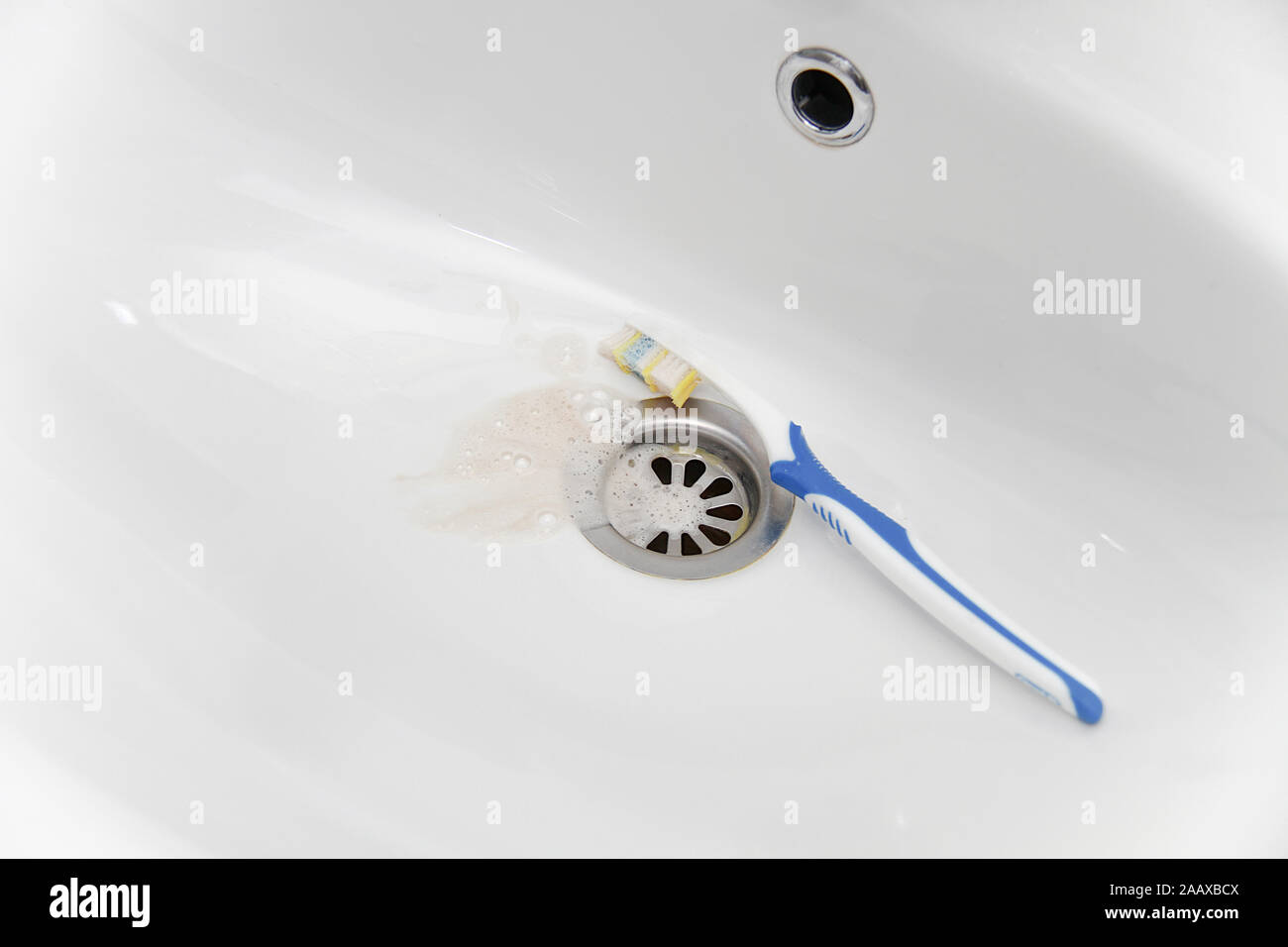 Blood and toothpaste on the toothbrush after cleaning and washing teath ...