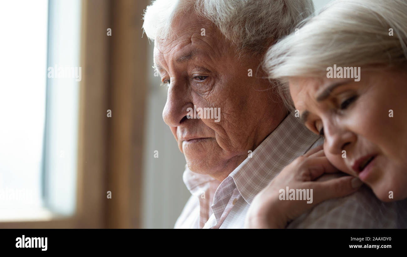 Worried middle aged woman embracing upset old man Stock Photo - Alamy