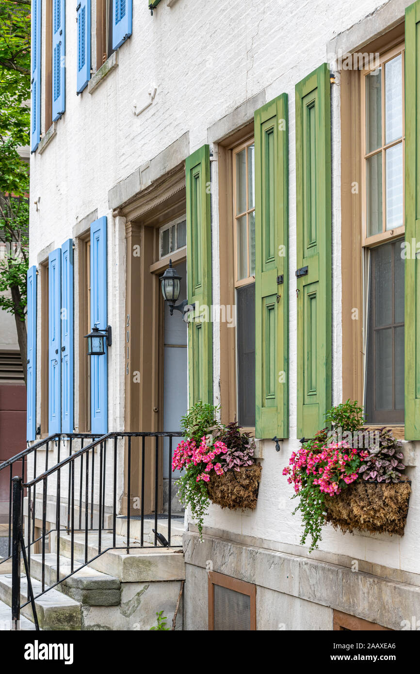 Window boxes and colourful shutters adorn a traditional residential ...