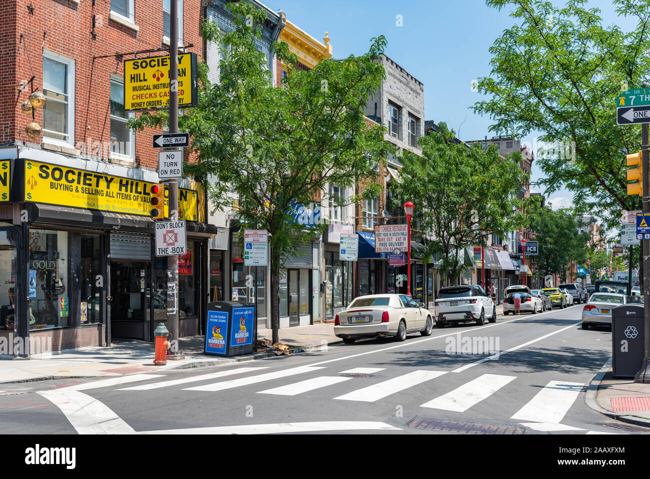 Tree lined South Street in Philadelphia at the junction with S 7th St ...