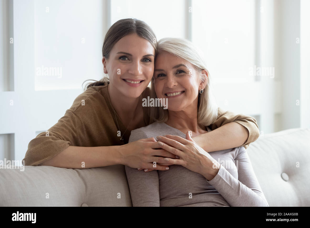 Portrait young woman embracing elderly hi-res stock photography and ...