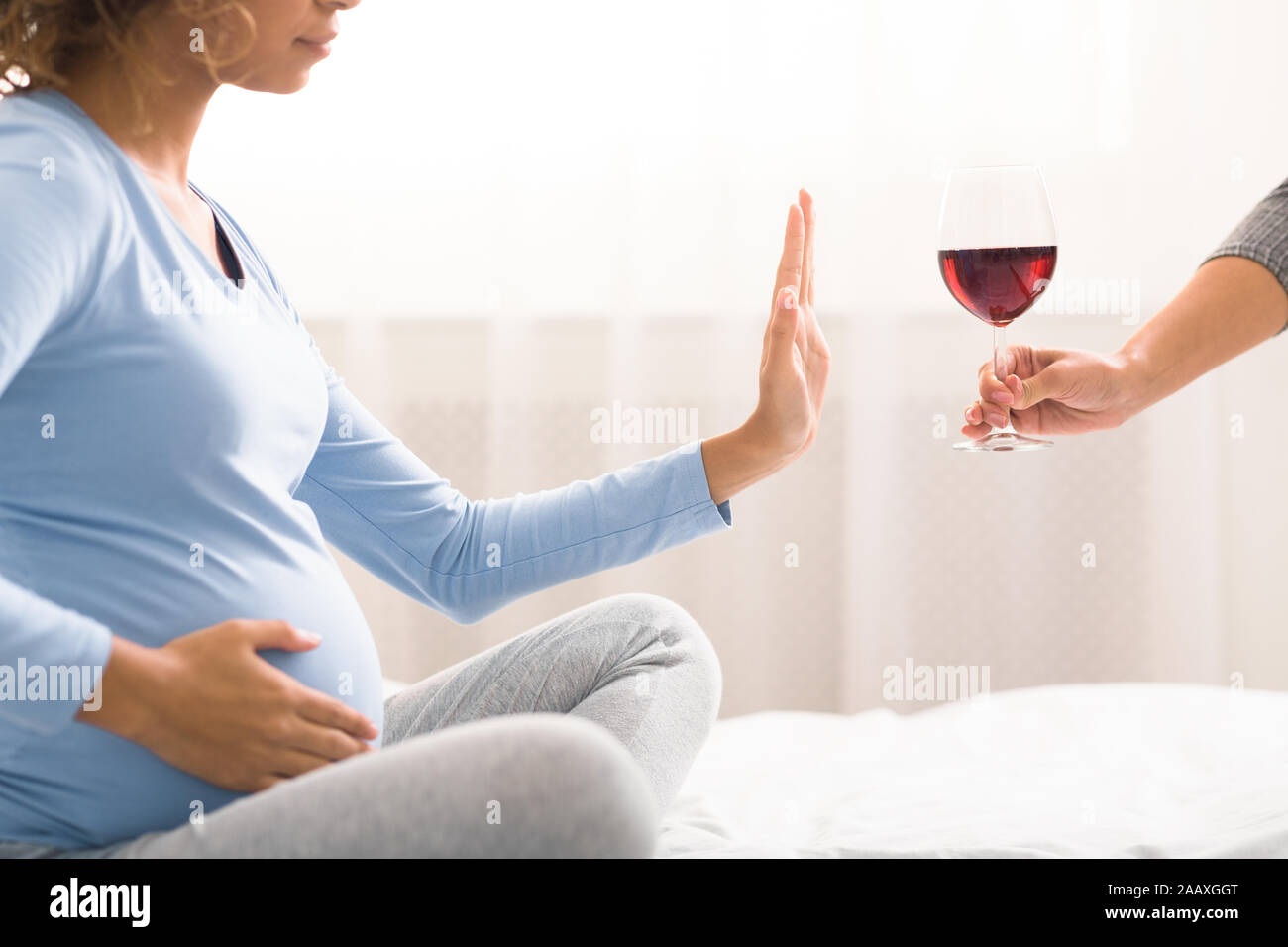 Alcohol prohibited. Expectant woman refusing to drink wine Stock Photo ...