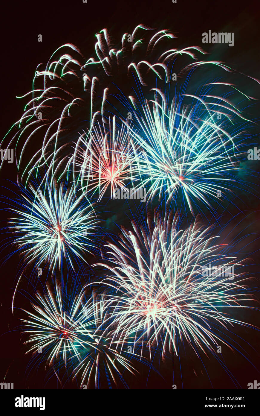 A bright and colorful firework display of smoke light color and blurred ...