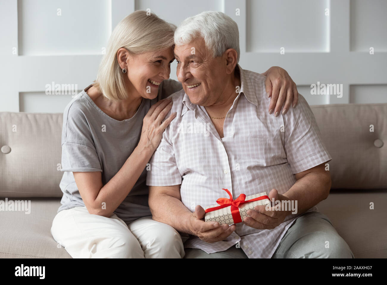 Happy older 70s man feeling thankful to wife for present Stock Photo ...