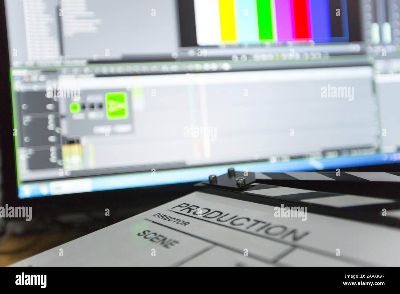 Movie clapper and editing room in background Stock Photo - Alamy