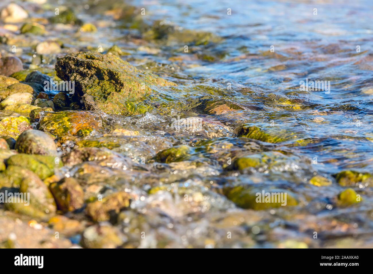 Sea stones background, ocean wave at the beach coast Stock Photo - Alamy