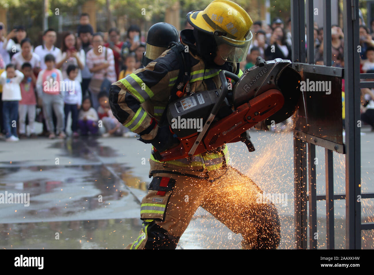 Xiamen, China. 24th Nov, 2019. A firefighter demonstrates a rescue ...