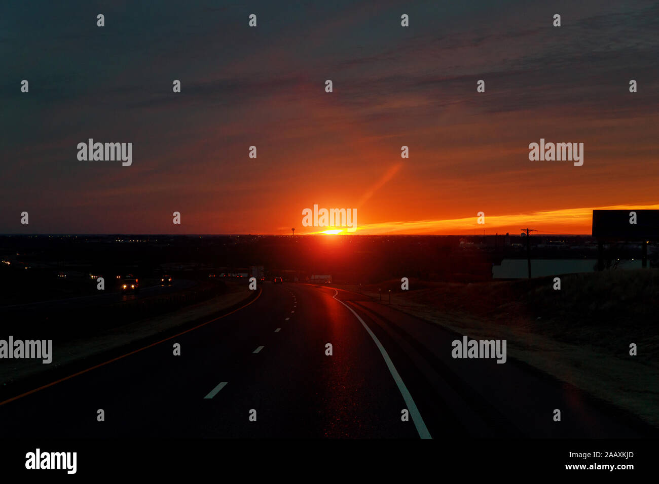 Driving in sunset road view with cars in front Stock Photo - Alamy