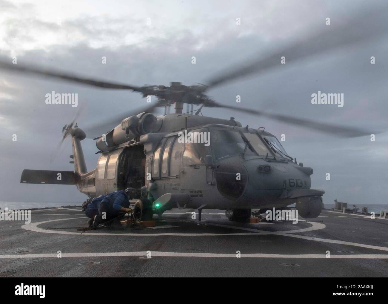 PACIFIC OCEAN (Nov. 21, 2019) Sailors secure an MH-60S Sea Hawk ...