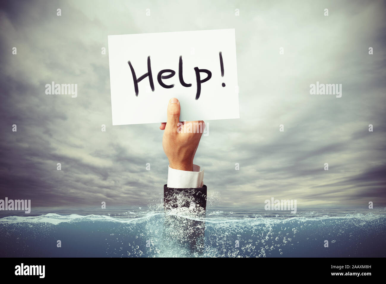 Businessman drowning in the sea with a hand holding a sheet of paper ...