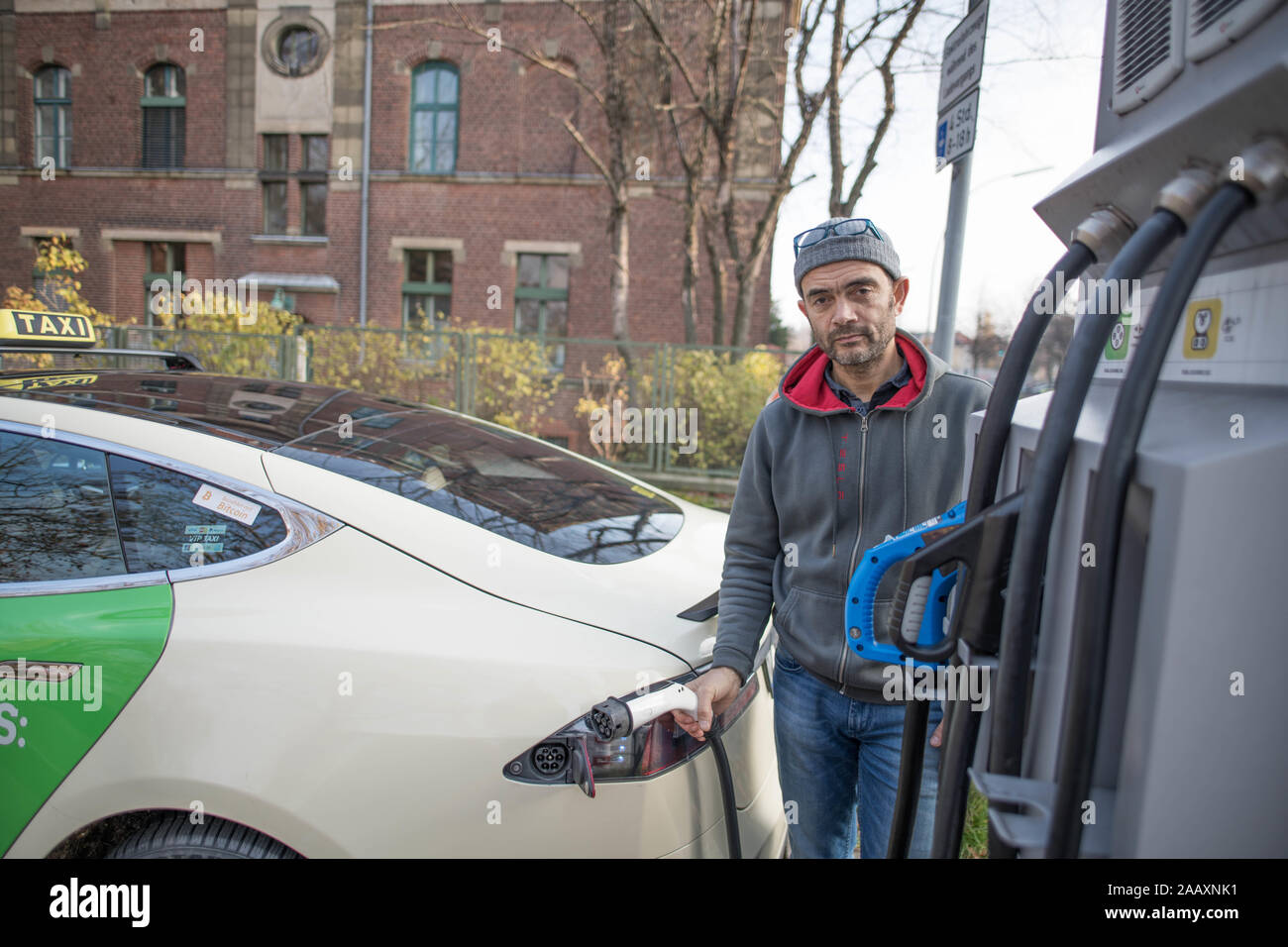 Berlin, Germany. 24th Nov, 2019. Martin Doll charges his Tesla taxi at ...