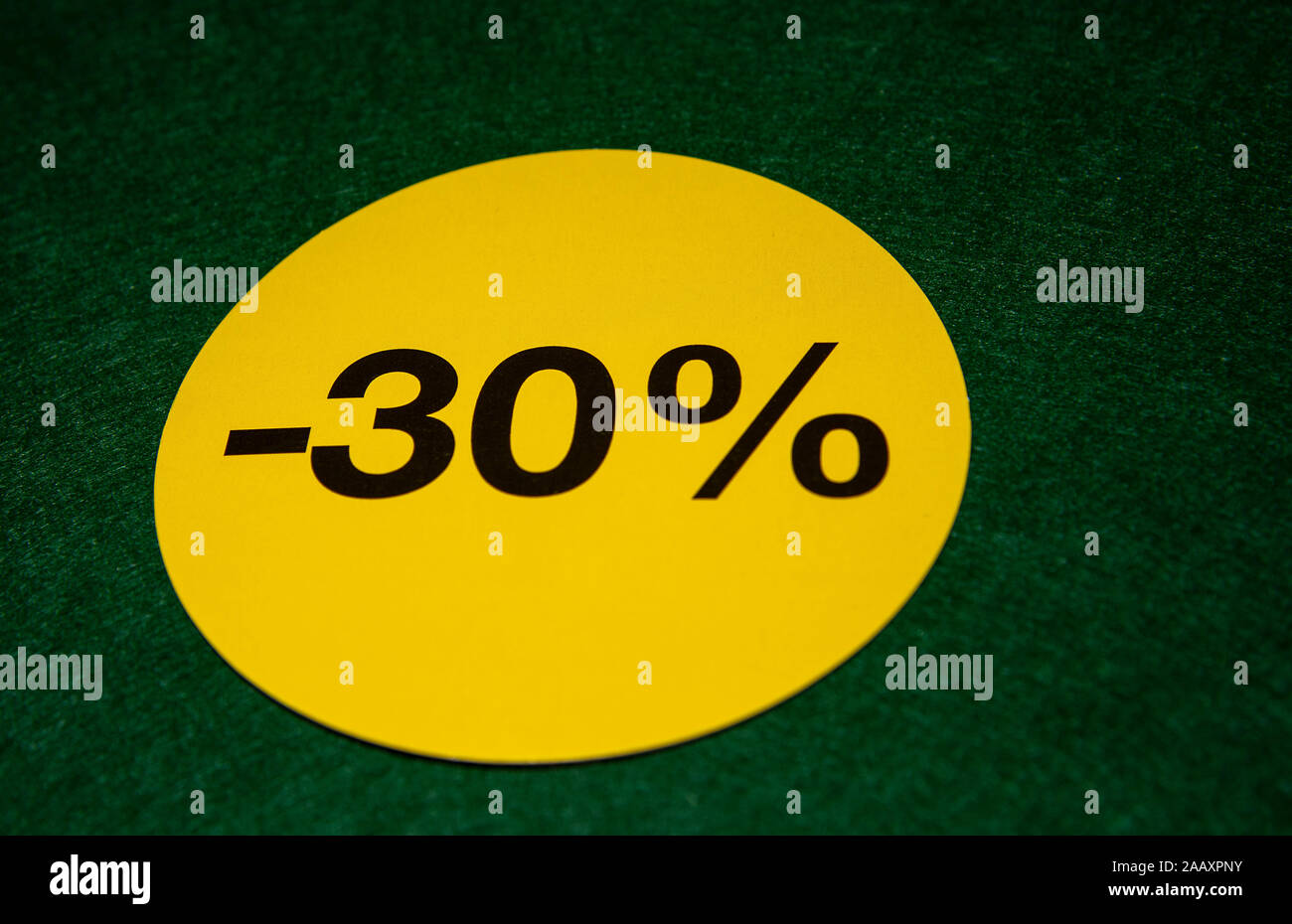 Yellow cardboard circle with the inscription 30 percent Stock Photo - Alamy