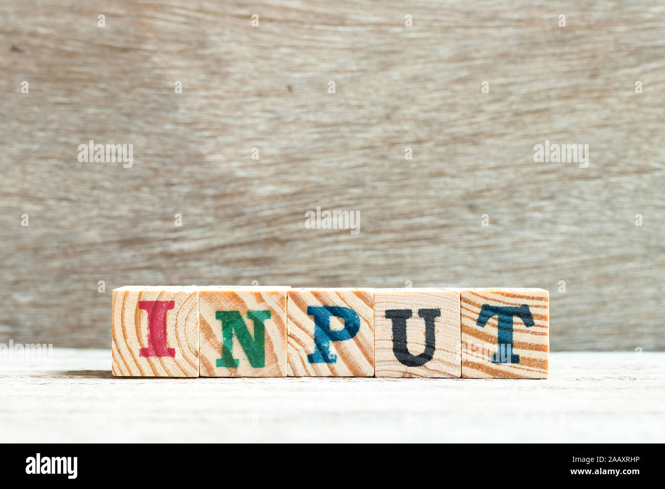 Letter block in word input on wood background Stock Photo - Alamy