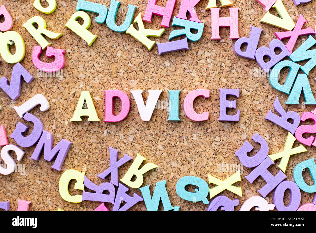 Color alphabet in word advice with another letter as frame on cork ...