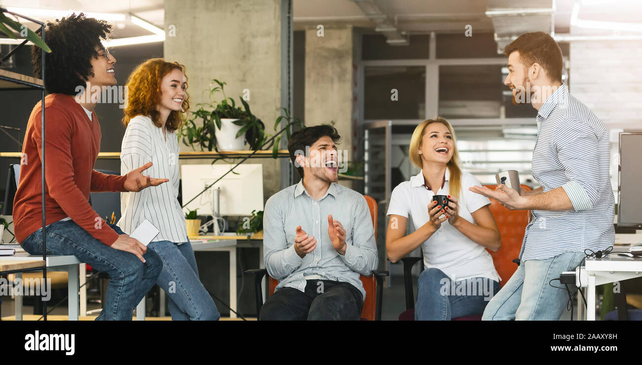 Group of colleagues laughing together during coffee break Stock Photo ...