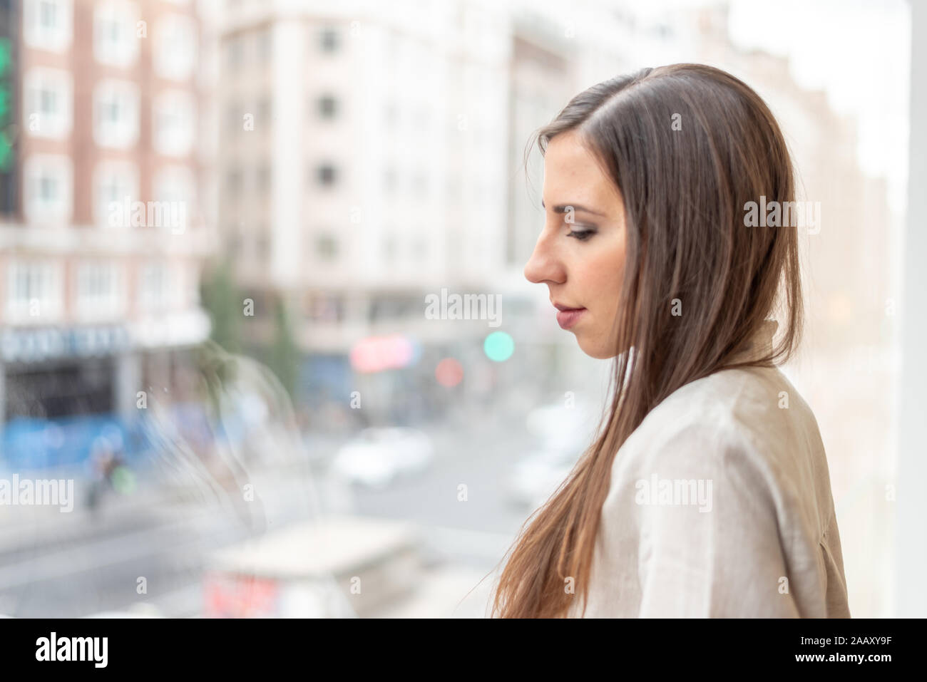 Girl looking longingly at the balcony in Madrid, Spain Stock Photo - Alamy