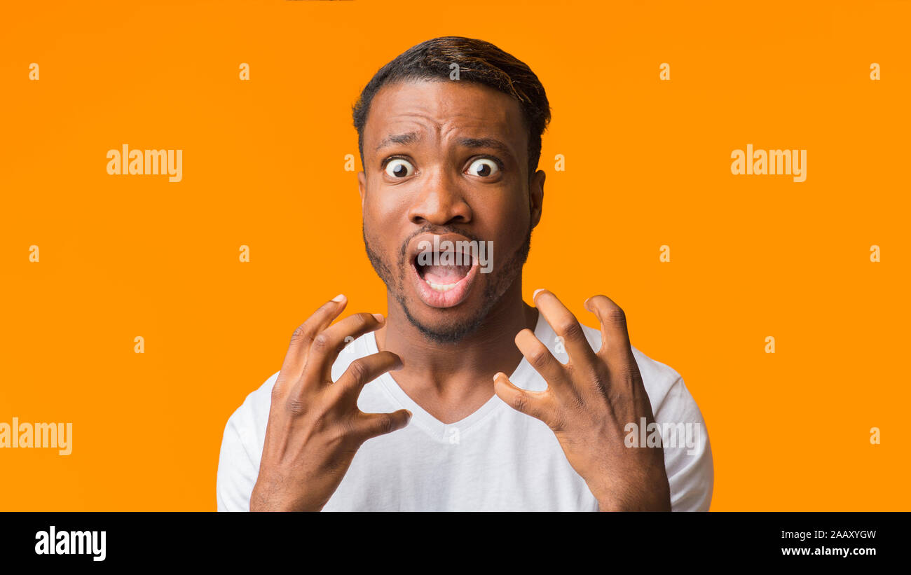 Frightened Black Man Screaming In Fear Standing Over Orange Background ...