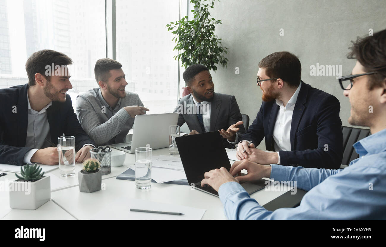 Business meeting. Cheerful men discussing successful contract Stock ...