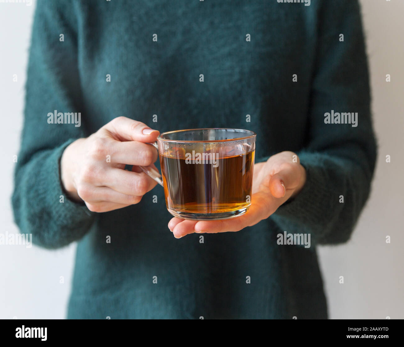 Tea glass cup in girls hand Stock Photo - Alamy