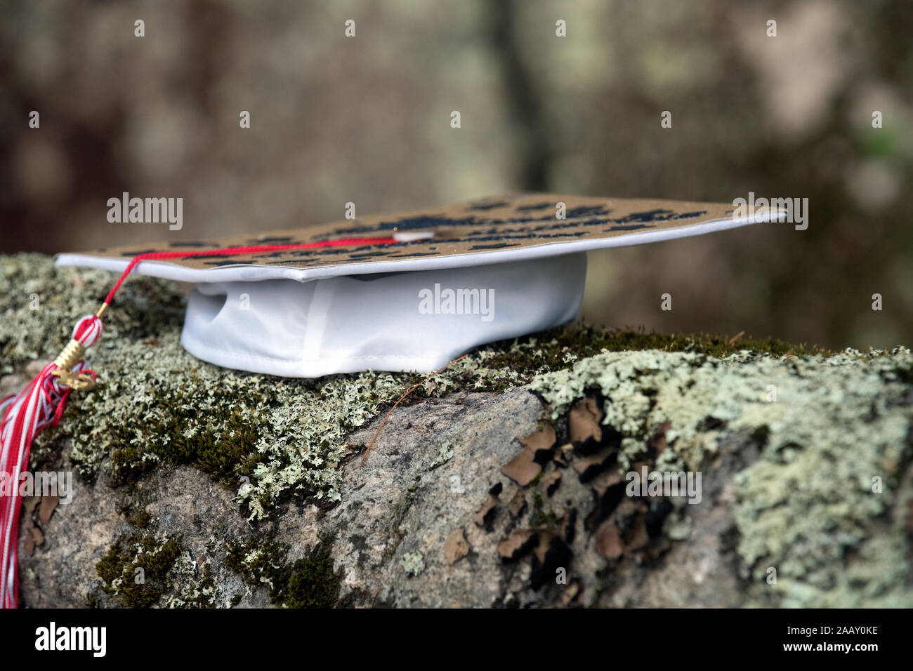Graduation cap placed on rocck Stock Photo - Alamy
