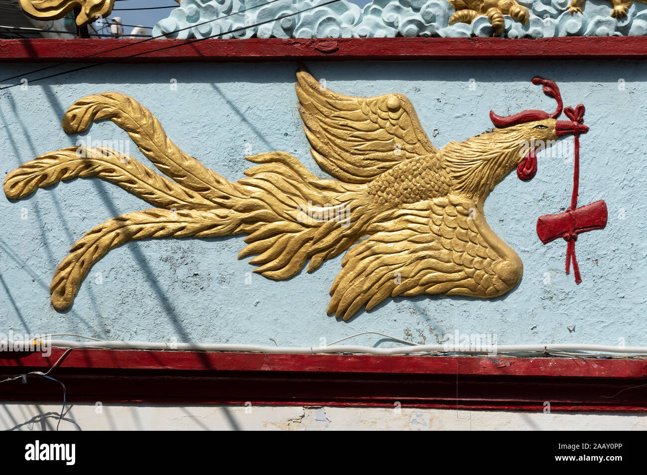 A Buddhist Golden Rooster symbol on the front of a temple in Vietnam ...