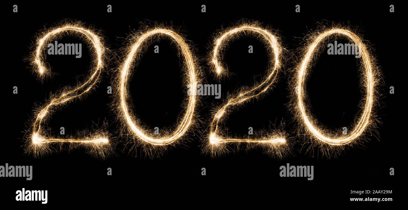 2020 written with sparkling holiday font on black background Stock ...
