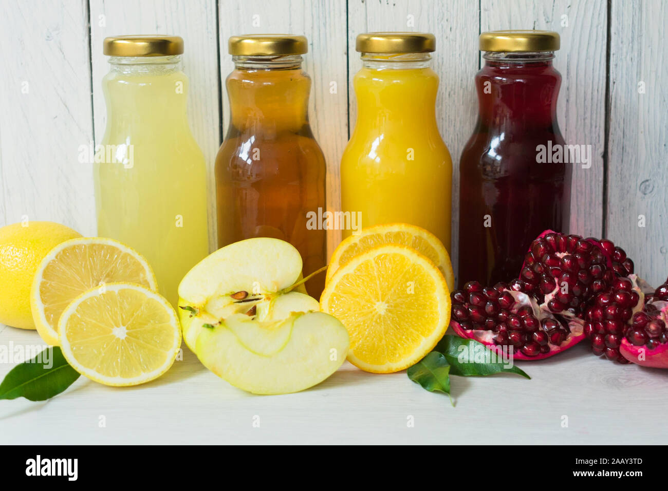 Four types of juice (pomegranate, apple, lemon, orange juice) in glass ...