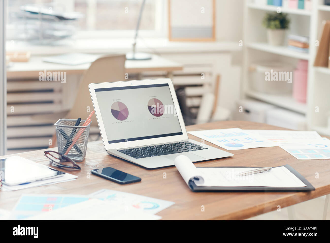 Background image of modern office interior with laptop on wooden table ...