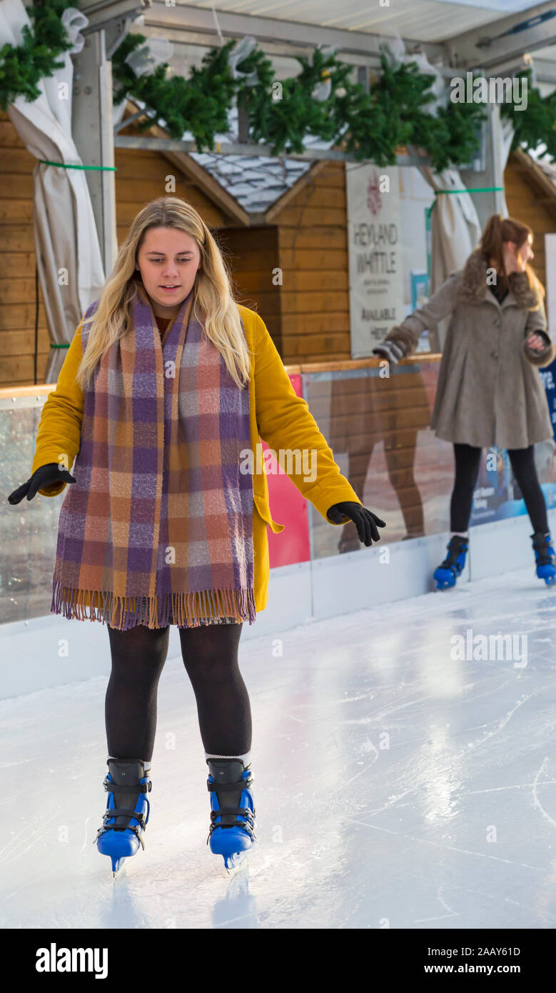 Ice skaters having fun on the ice skating rink on Winchester Cathedral ...