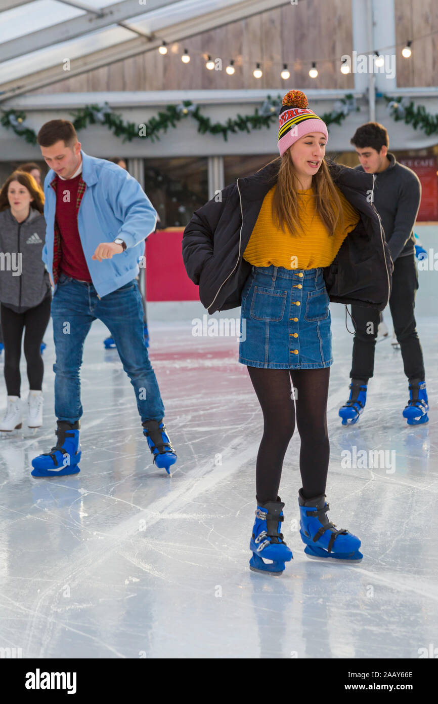 Ice skaters having fun on the ice skating rink on Winchester Cathedral ...