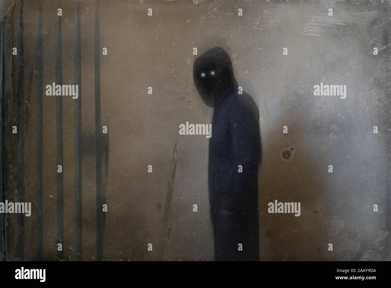 A mysterious spooky hooded figure with glowing eyes standing inside ...