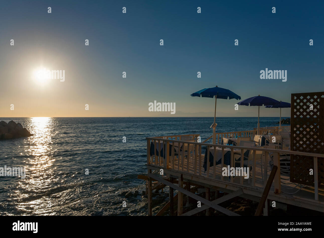 Terrace on the seaside with tables umbrella and dinind tables, Beach of ...