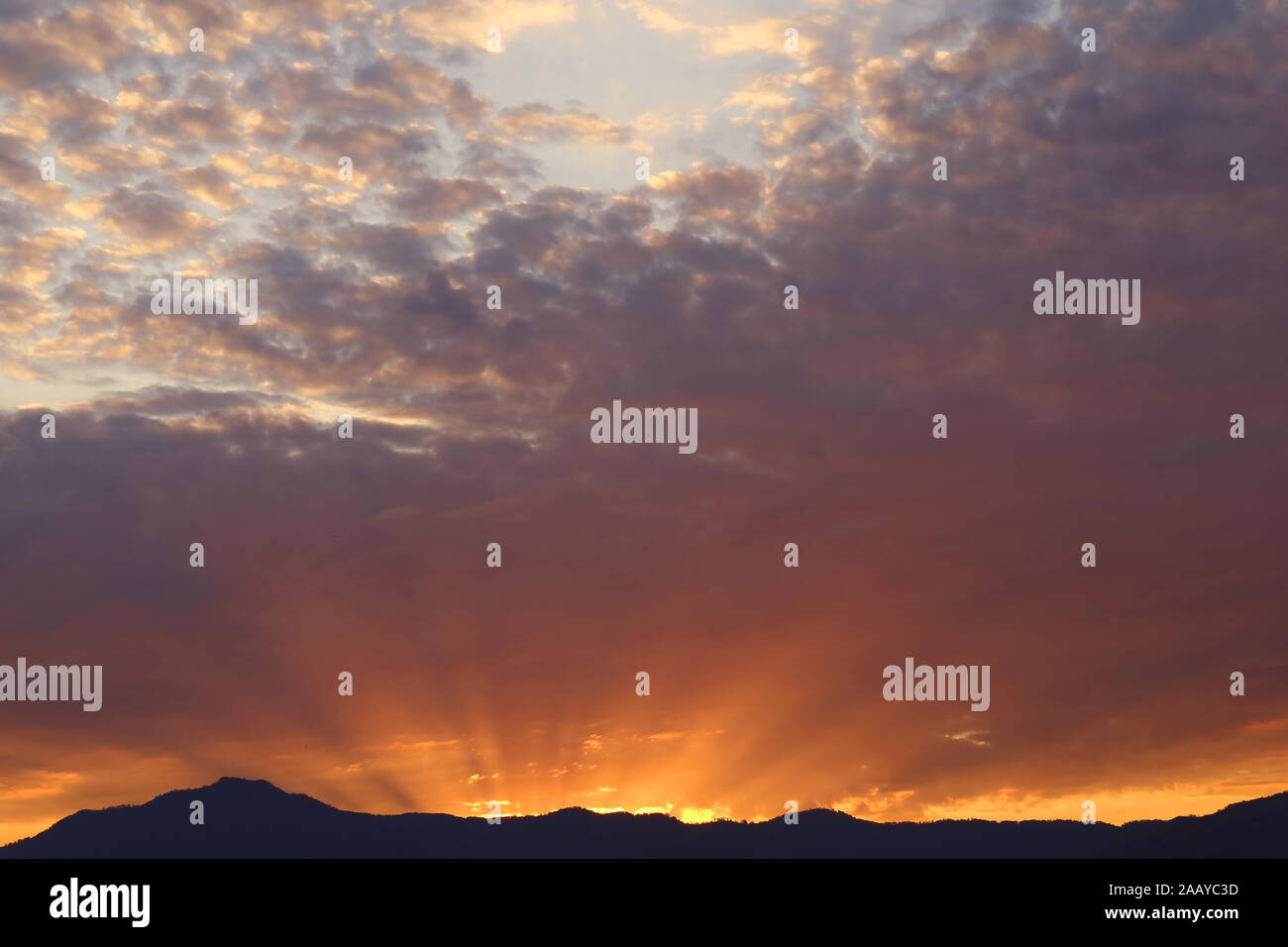 Sun Ray of the Rising Sun Shining from behind the Mountain Stock Photo ...