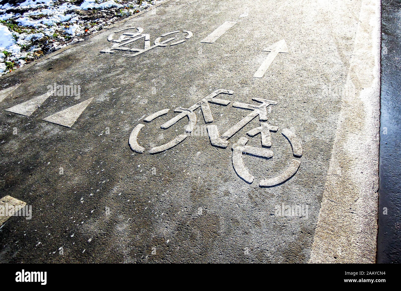 Bike lane with road symbols painting on asphalt. Bicycle sign on street ...